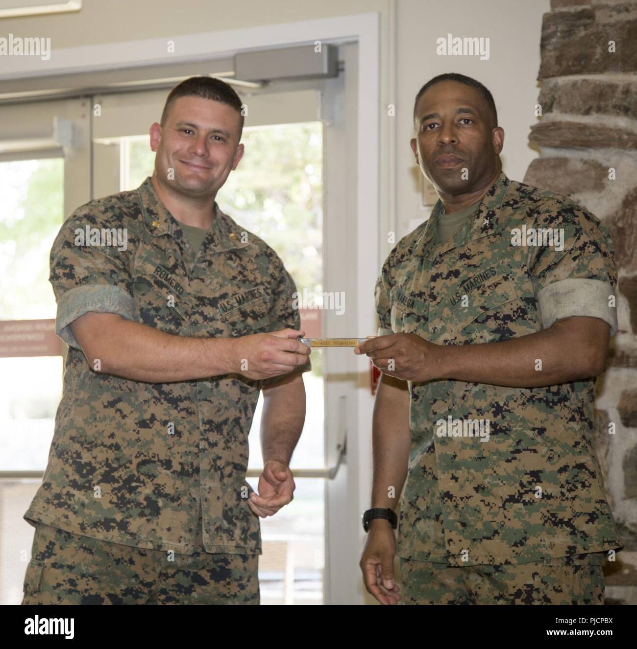 Major Alfredo Romero, S-3 Officer, MCLB Barstow, presents outgoing ...