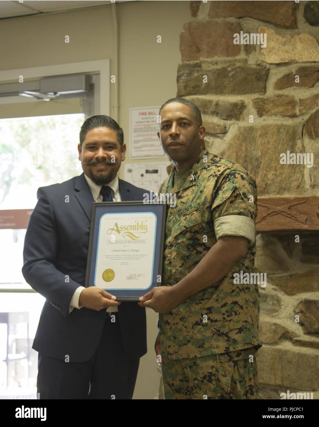 Colonel Sekou Karega, commanding officer, poses with Joshua Imeri ...