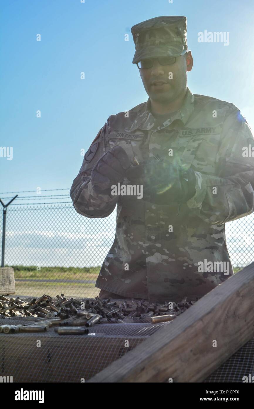 U.S. Army Reserve Sgt. Raymond Cintron sorts spent casings for turn in ...