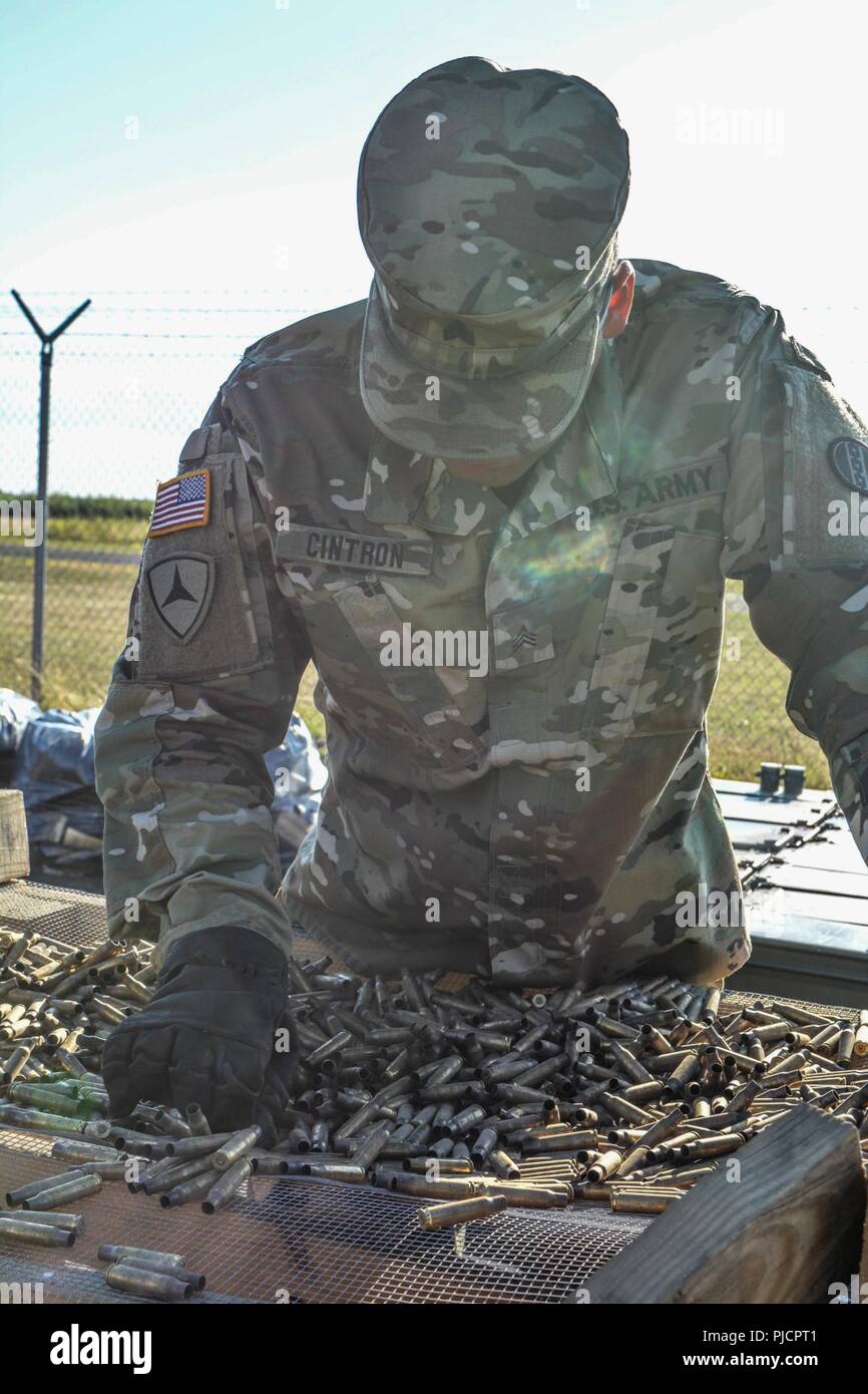 U.S. Army Reserve Sgt. Raymond Cintron sorts spent casings for turn in ...