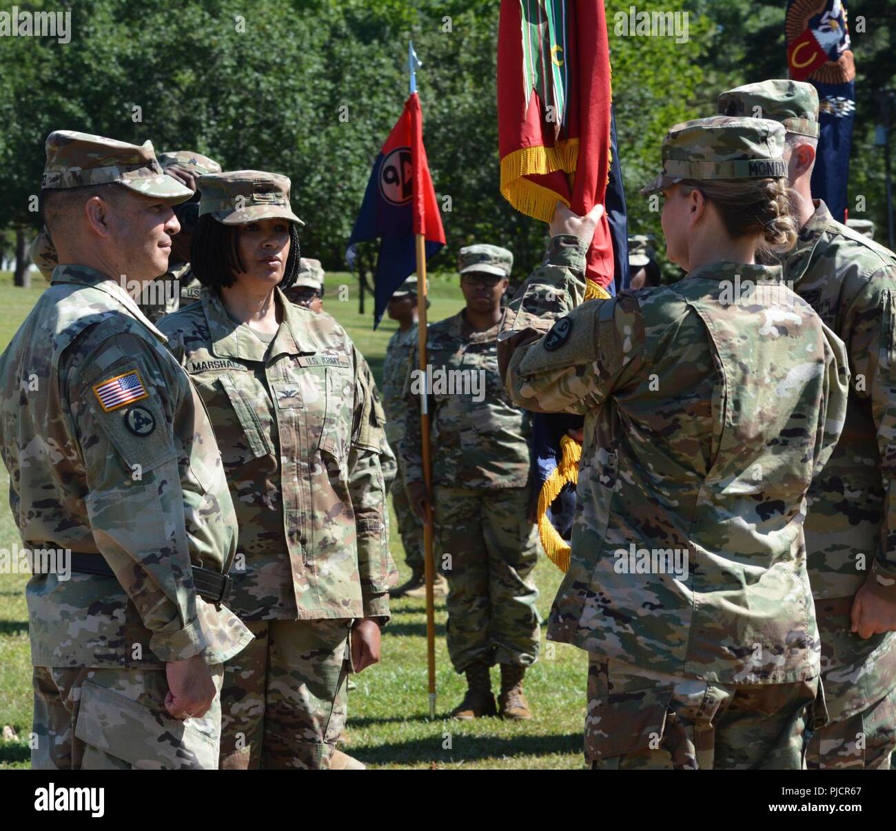 Col. Karen Monday-Gresham, incoming 4th Brigade commander (right) holds ...