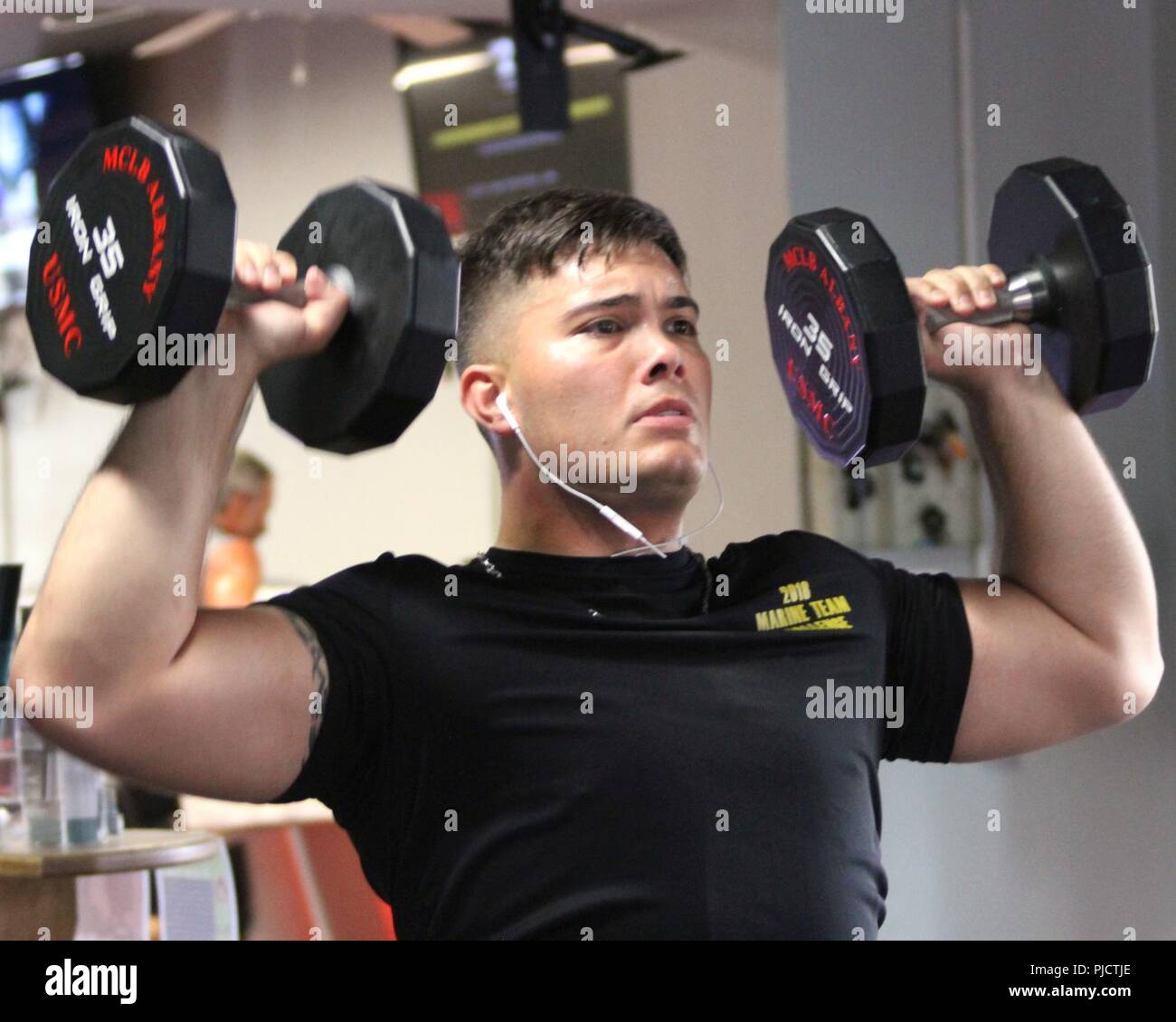 A handful of Marines participate in a weightlifting competition held at ...