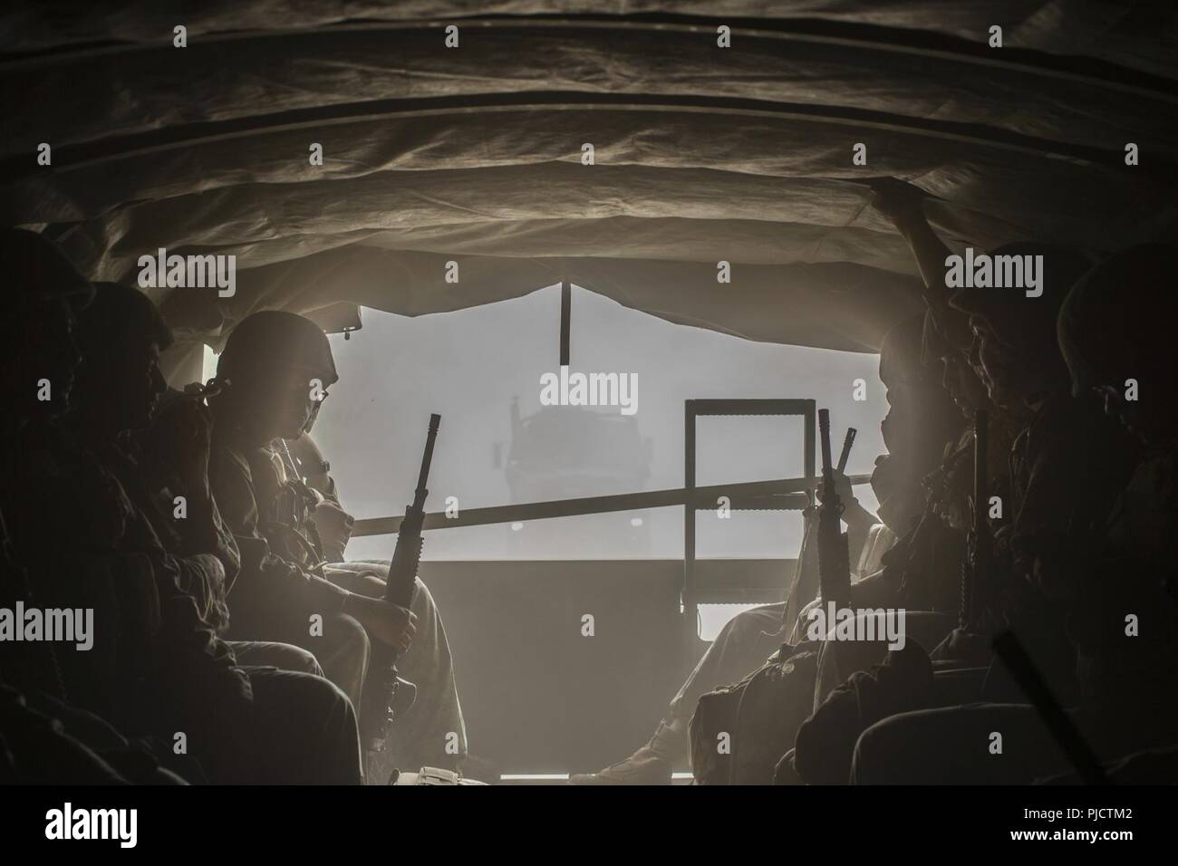 U.S. Marines with Marine Wing Support Squadron (MWSS) 171 ride in a 7 ...