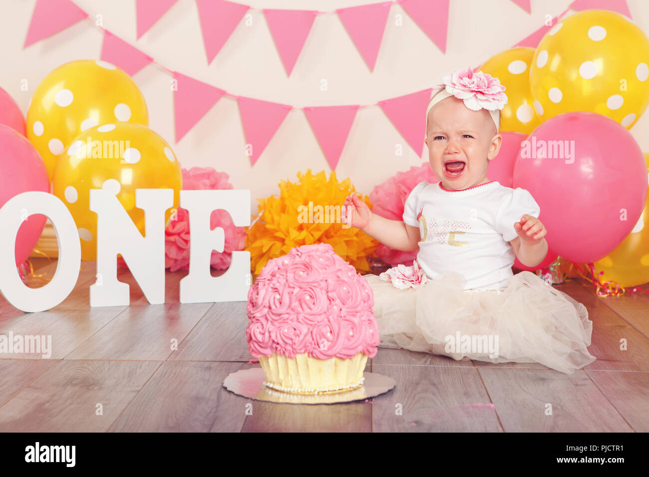 Portrait of crying upset Caucasian baby girl in tutu tulle skirt ...