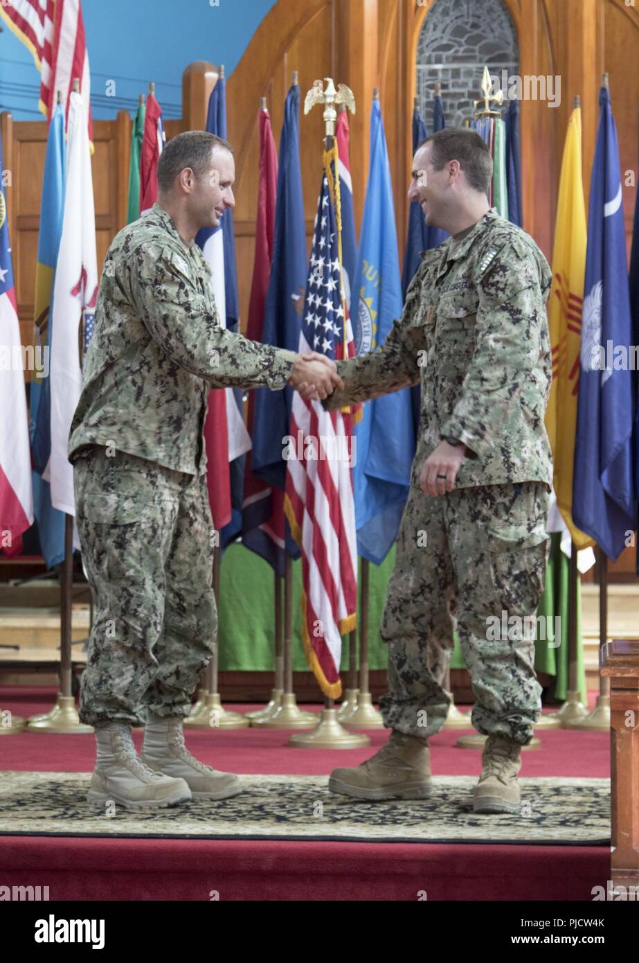 The Bull Ensign with the outgoing Maritime Security Detachment hands ...