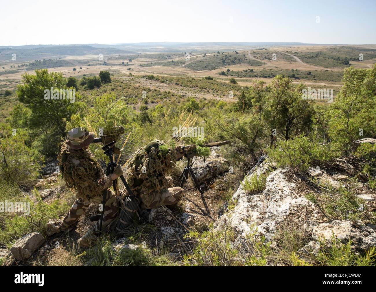 A Norwegian sniper team engages a target while camouflaged on July 13 ...