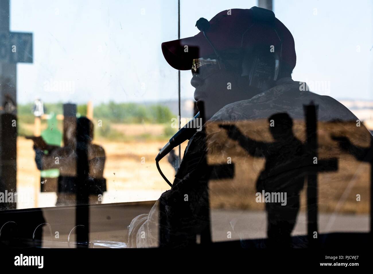 A Combat Arms Training and Maintenance (CATM) instructor watches as ...