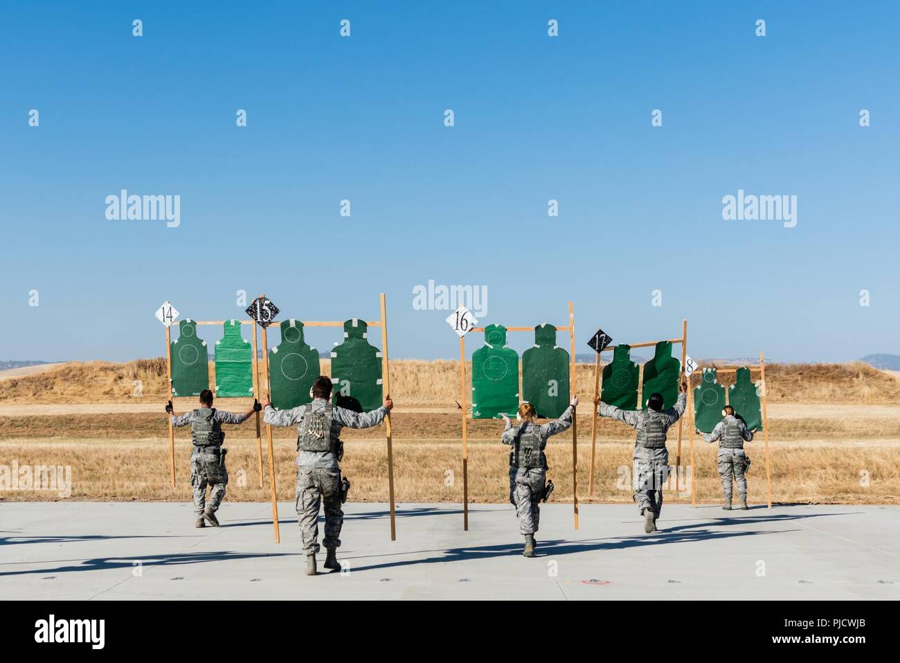 Airmen with the 9th Security Forces Squadron carry their targets before ...