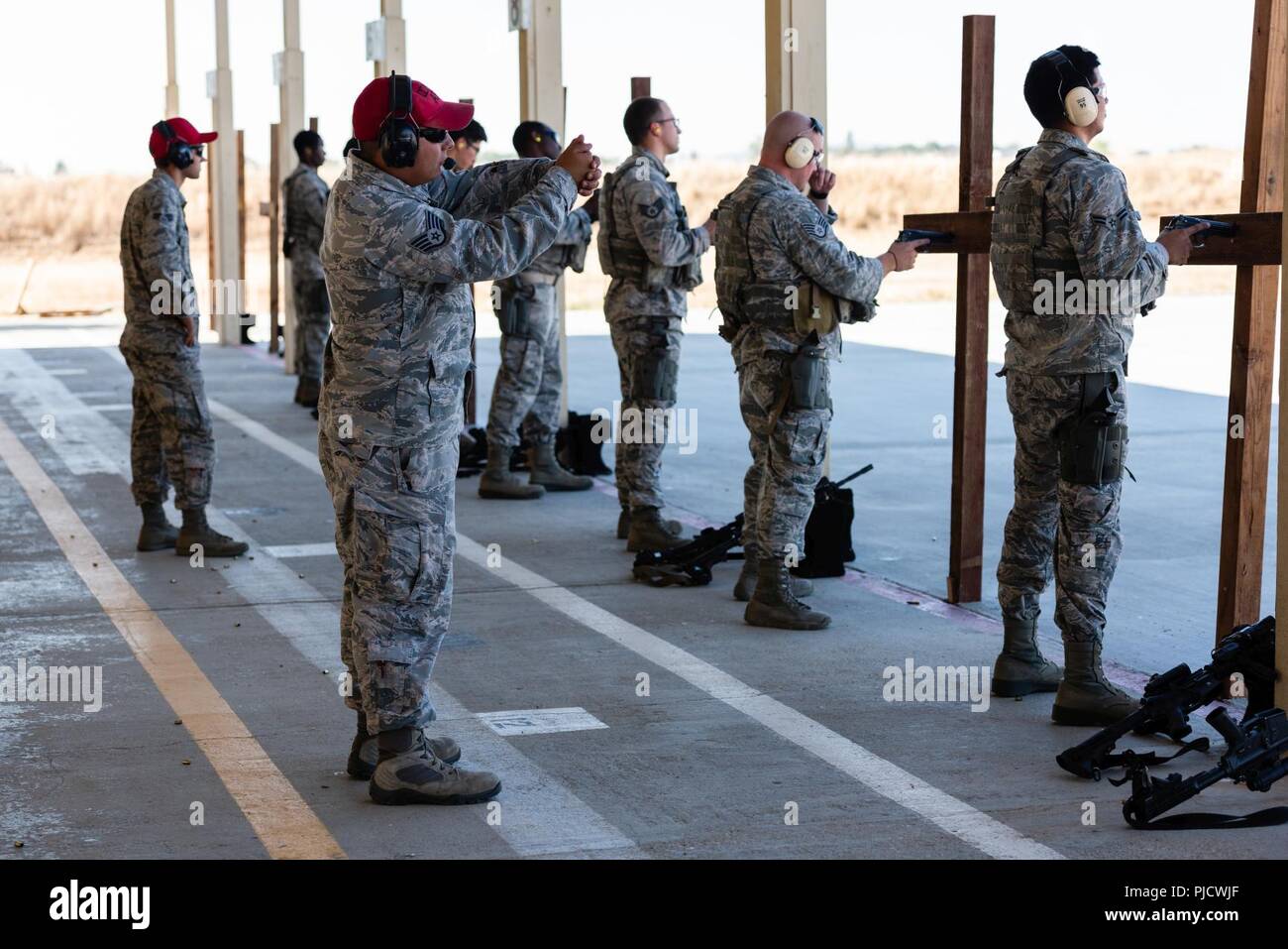 Combat Arms Training and Maintenance (CATM) instructors observe as ...