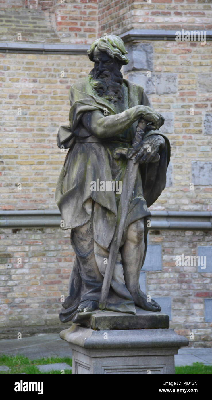 Statue in front of church of Our Lady in Bruges, Belgium Stock Photo ...