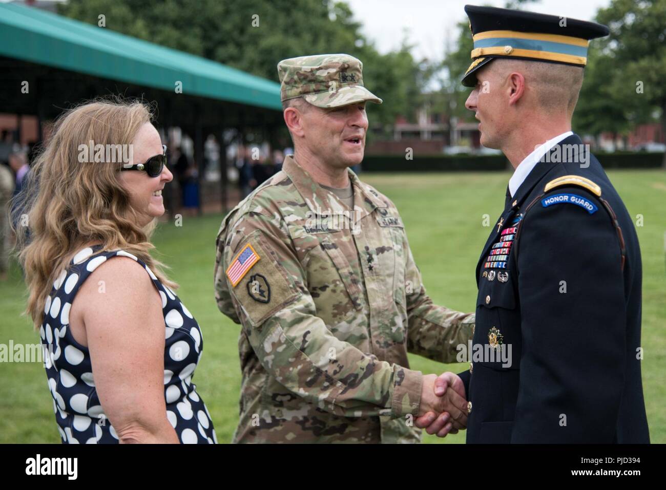 Maj. Gen, Bradley A. Becker (center), shakes hands with Col. Jason T ...