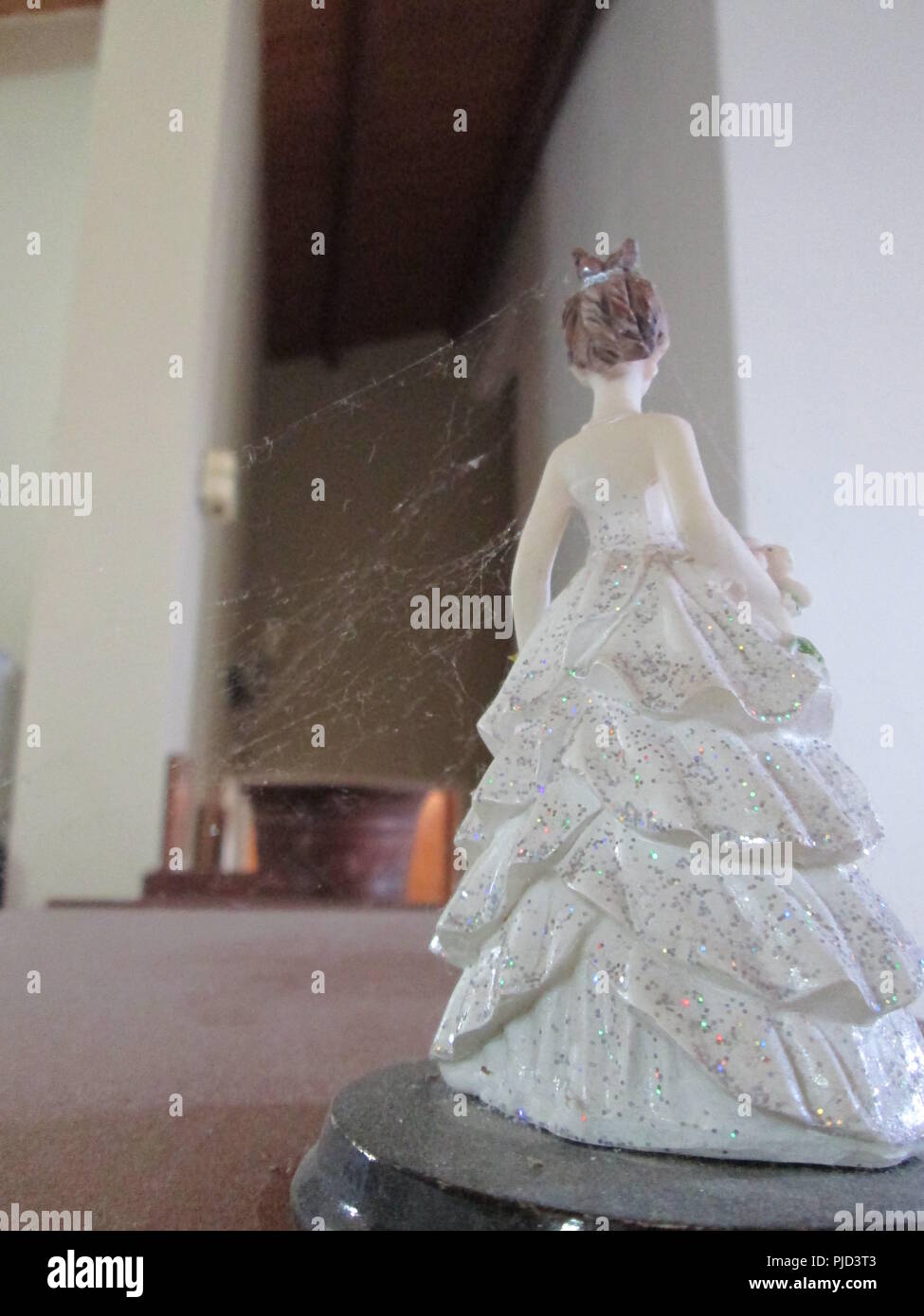 Ceramic doll with white wedding dress and cobweb cover Stock Photo - Alamy
