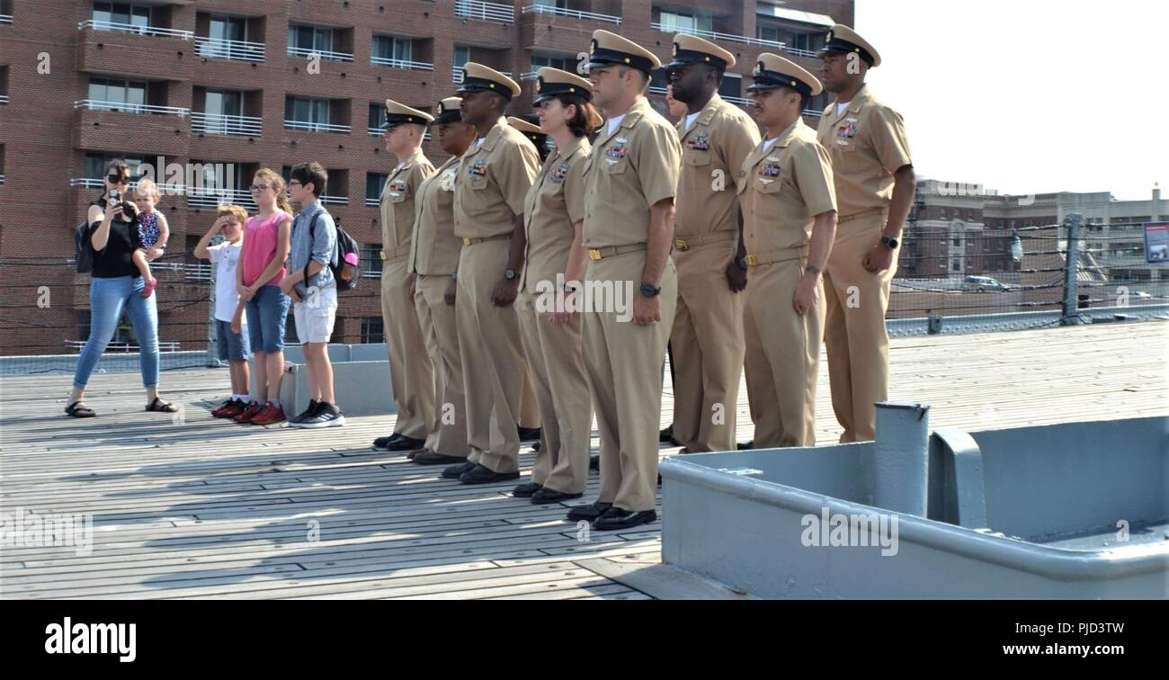 U.S Navy Service members stand at attention during a re-enlistment ...