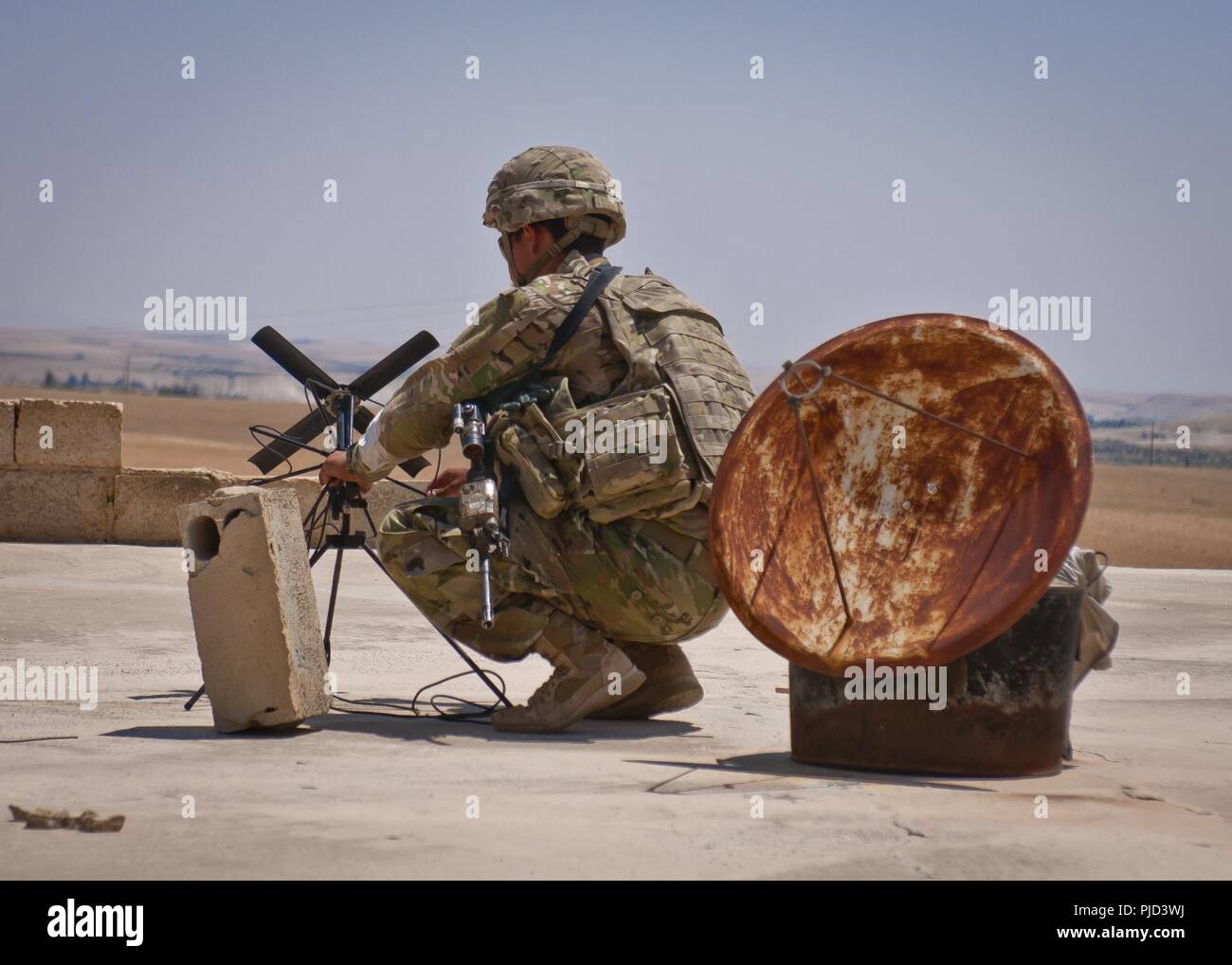A U.S. Soldier sets up an antenna in order to transmit a situational ...