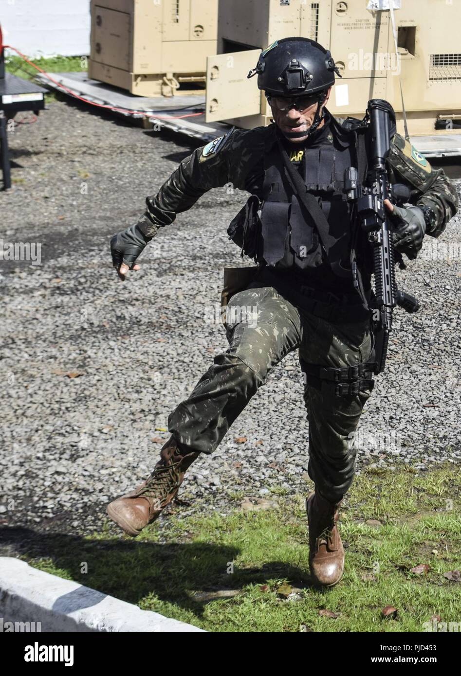 A Brazilian comando runs to an assault range as part of Fuerzas Comando ...