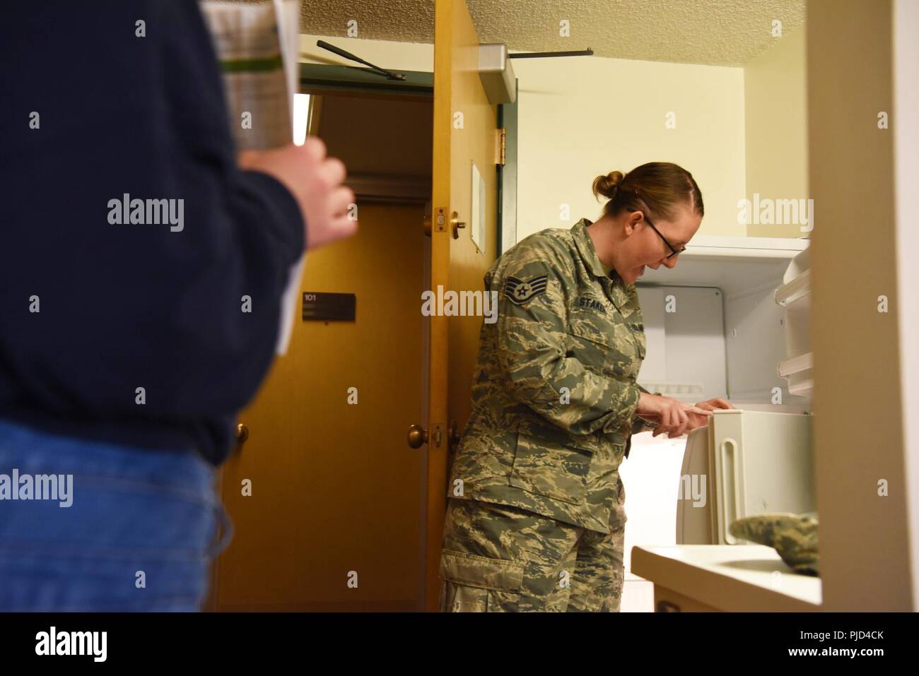Staff Sgt. Hailey Staker, an Airman dorm leader, inspects the ...