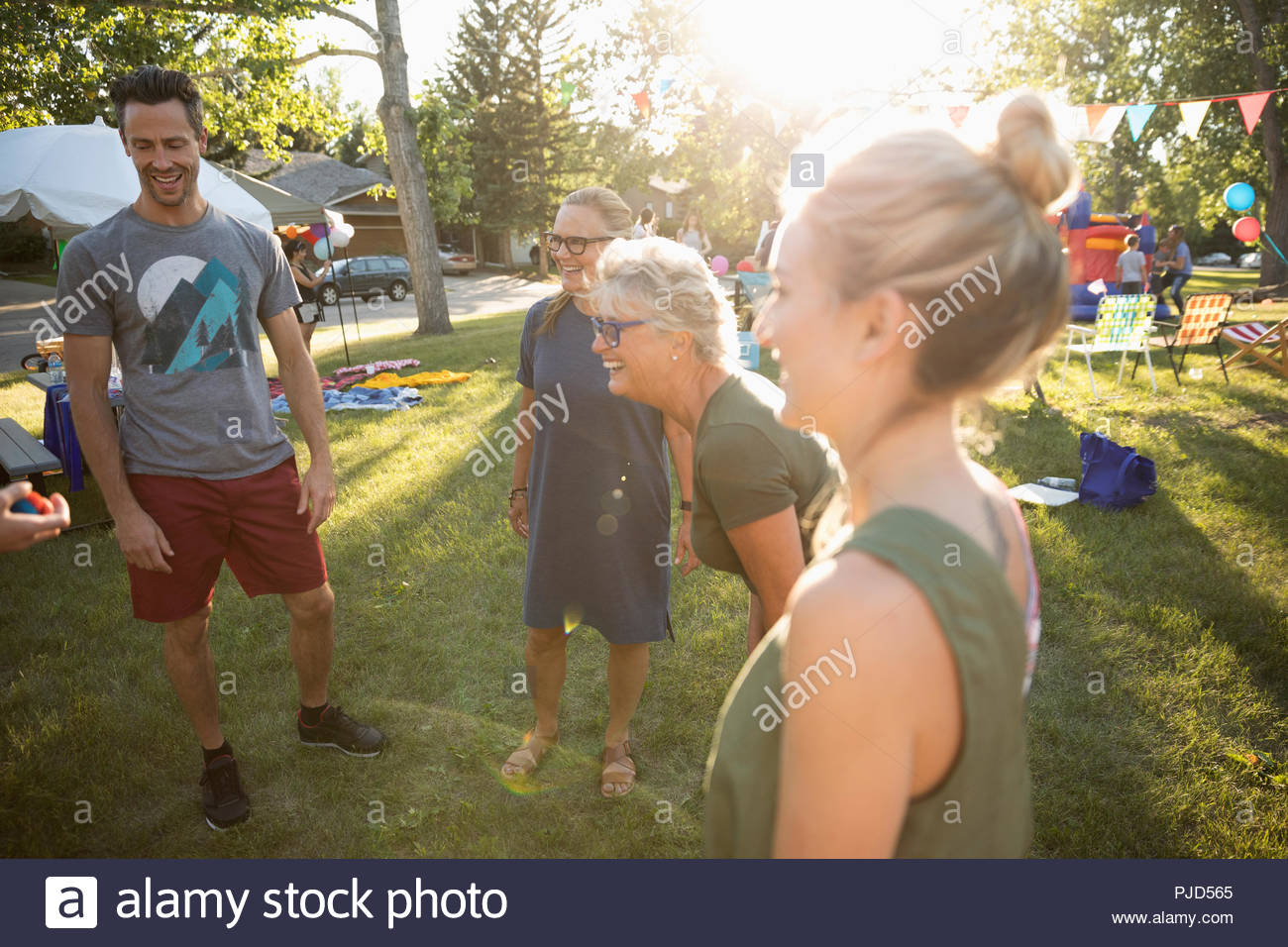 Happy neighbors enjoying summer neighborhood block party in sunny park ...