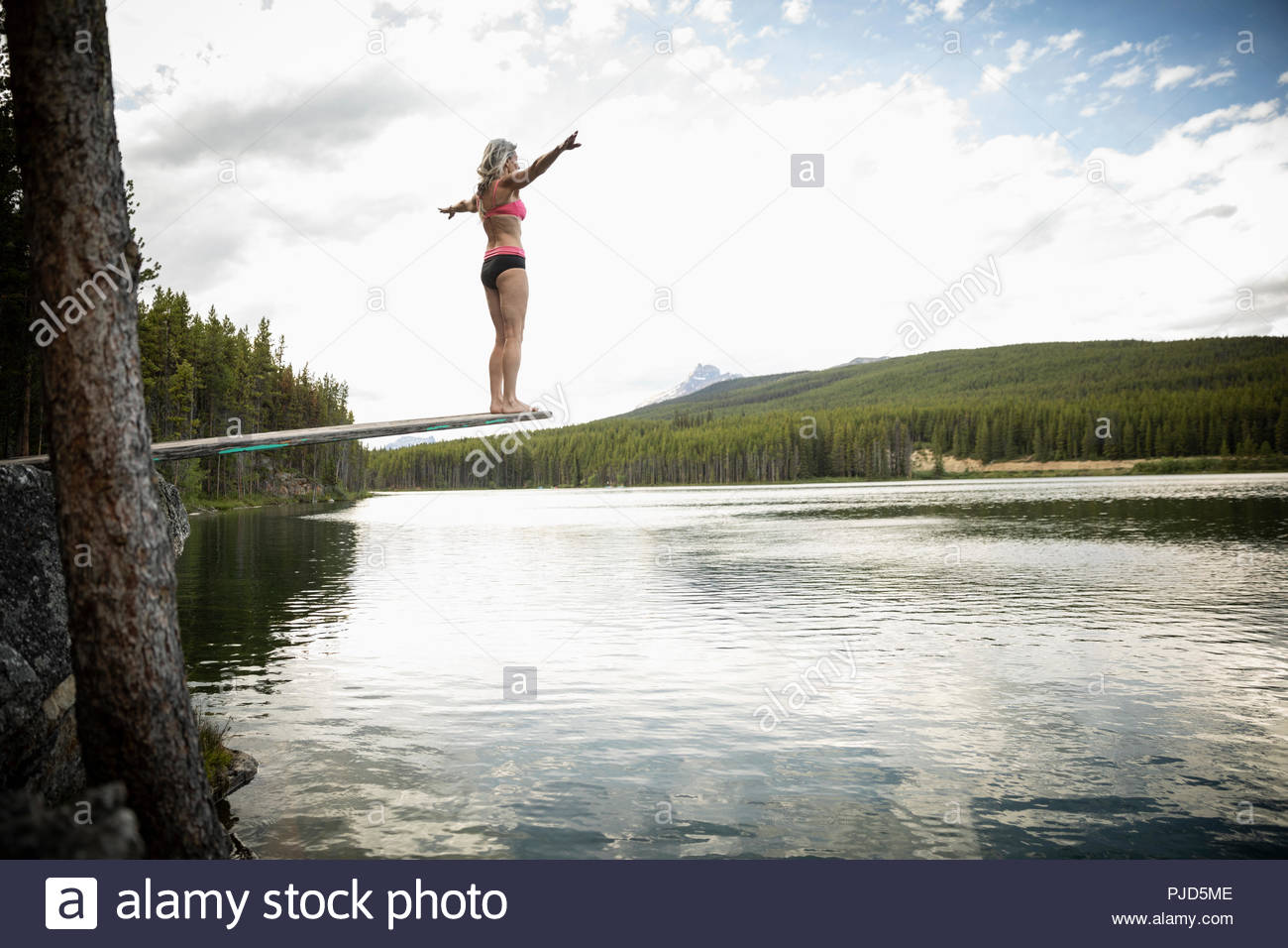 Mature woman standing on diving board hi-res stock photography and ...