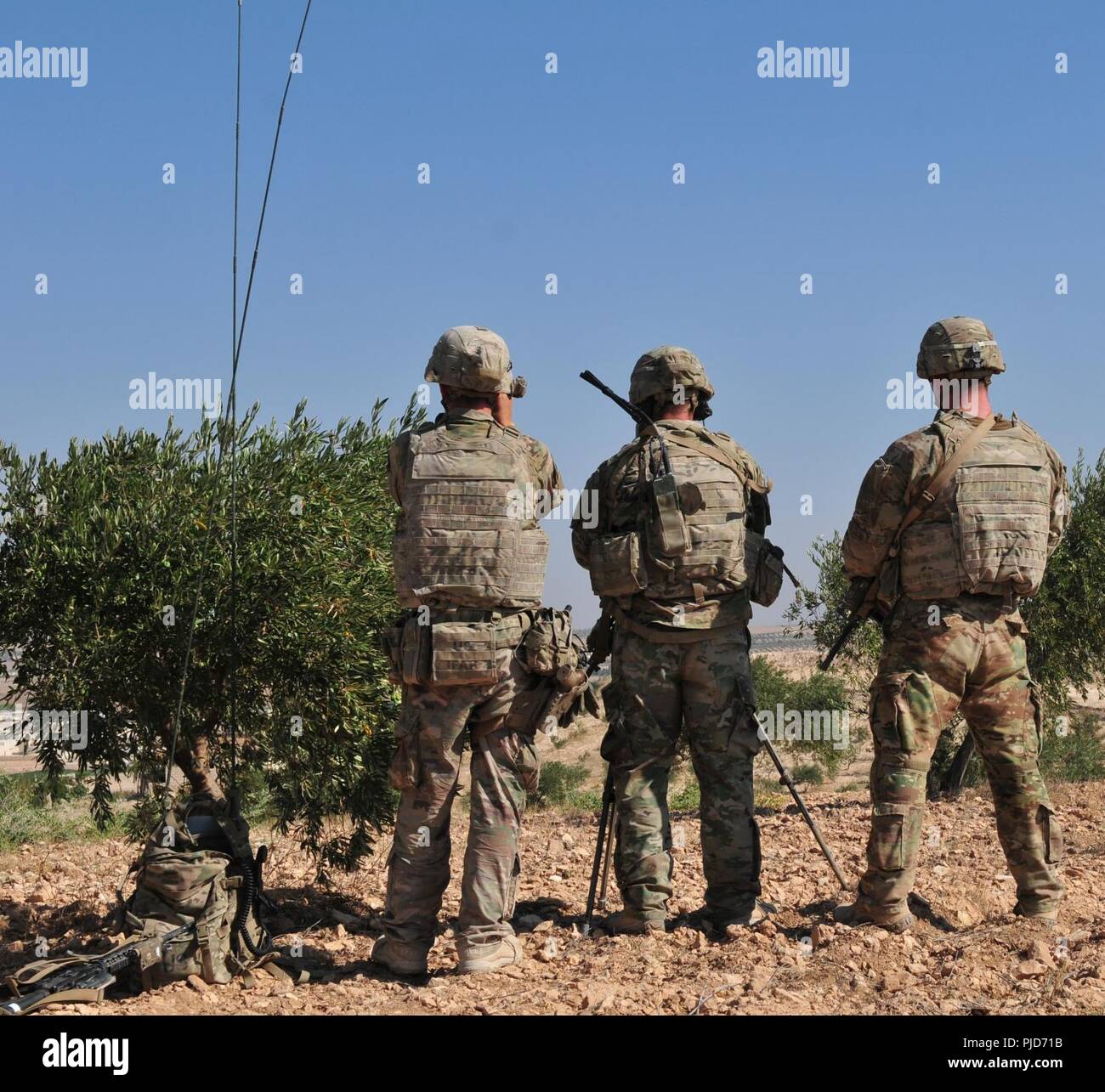 A group of U.S. Soldiers look out at the demarcation line during a ...