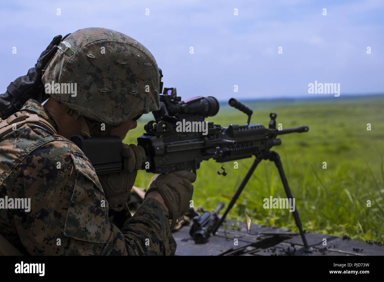 A U.S. Marine fires an M249 light machine gun at Combined Arms Training ...