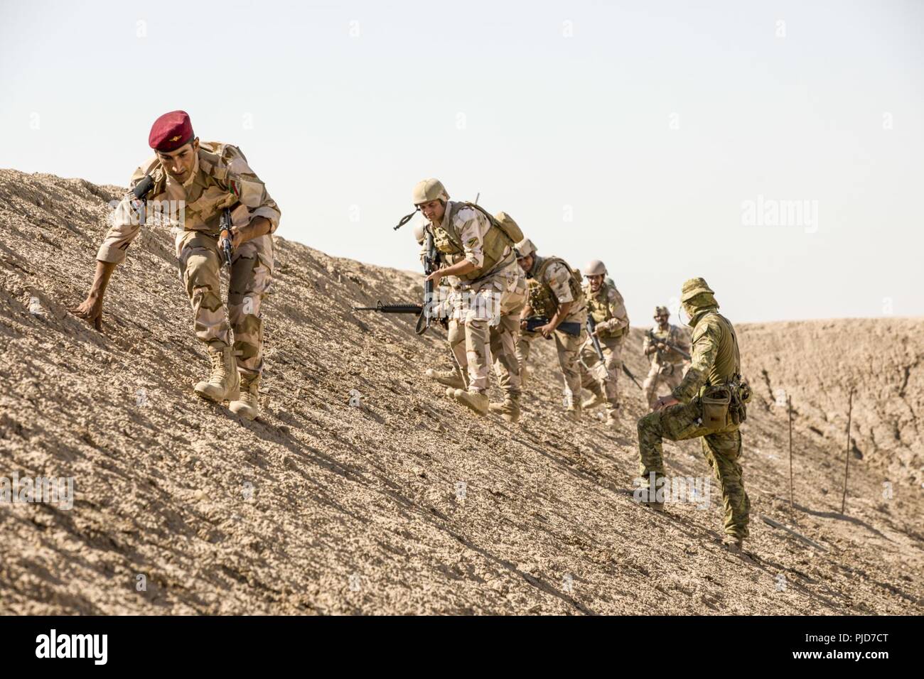 Australian army Cpl. Perrie Irwin, a Task Group Taji trainer, observes ...
