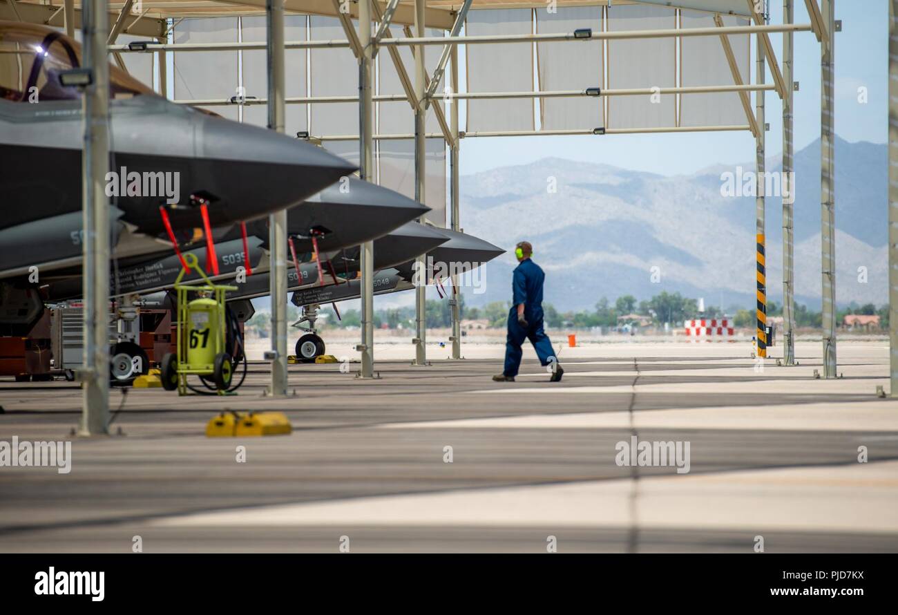 A crew chief assigned to the 61st Fighter Squadron approaches an F-35A ...