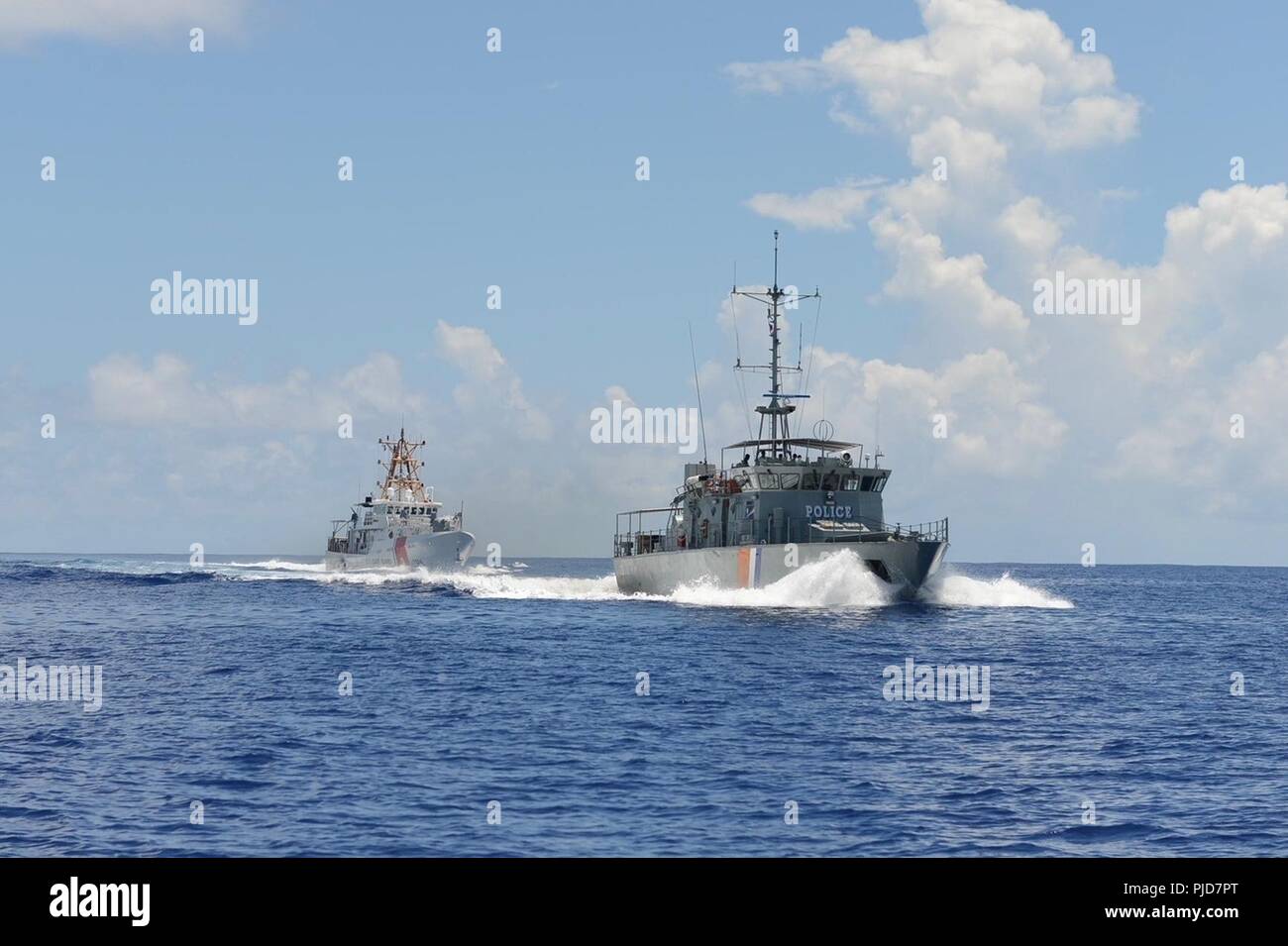 U.S. Coast Guard Cutter Oliver Berry (WPC 1124) sails in formation with ...