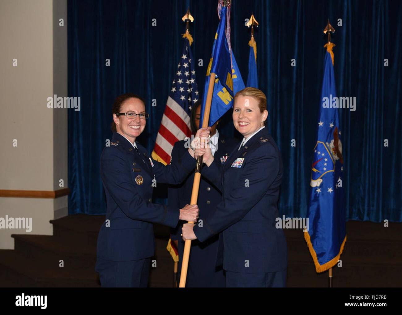Colonel Stacy Jo Huser, 90th Missile Wing commander, passes the guidon ...