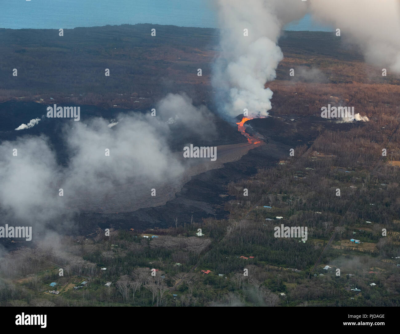 Aerial view of Kilauea Volcano east rift zone erupting hot lava from ...
