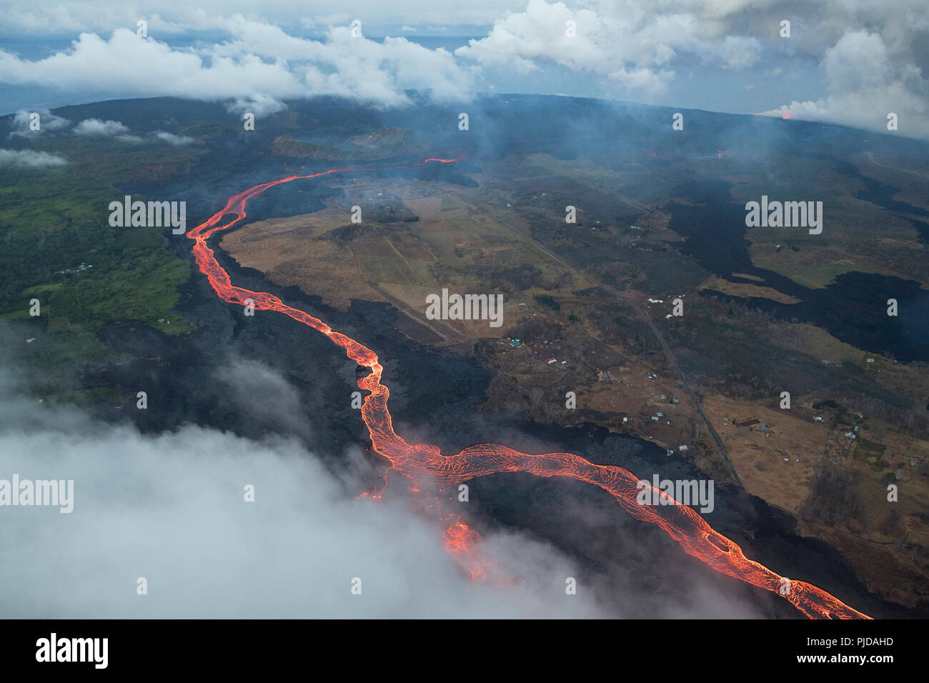 river of hot lava flows from fissure 8 in Kilauea Volcano east rift ...