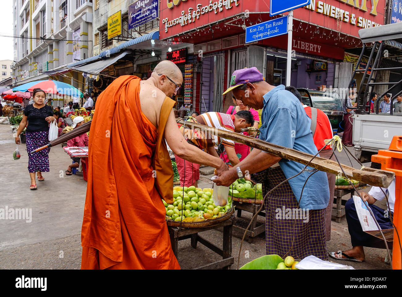 Yangon, Myanmar - Feb 26, 2016. A monk at street market in Yangon ...
