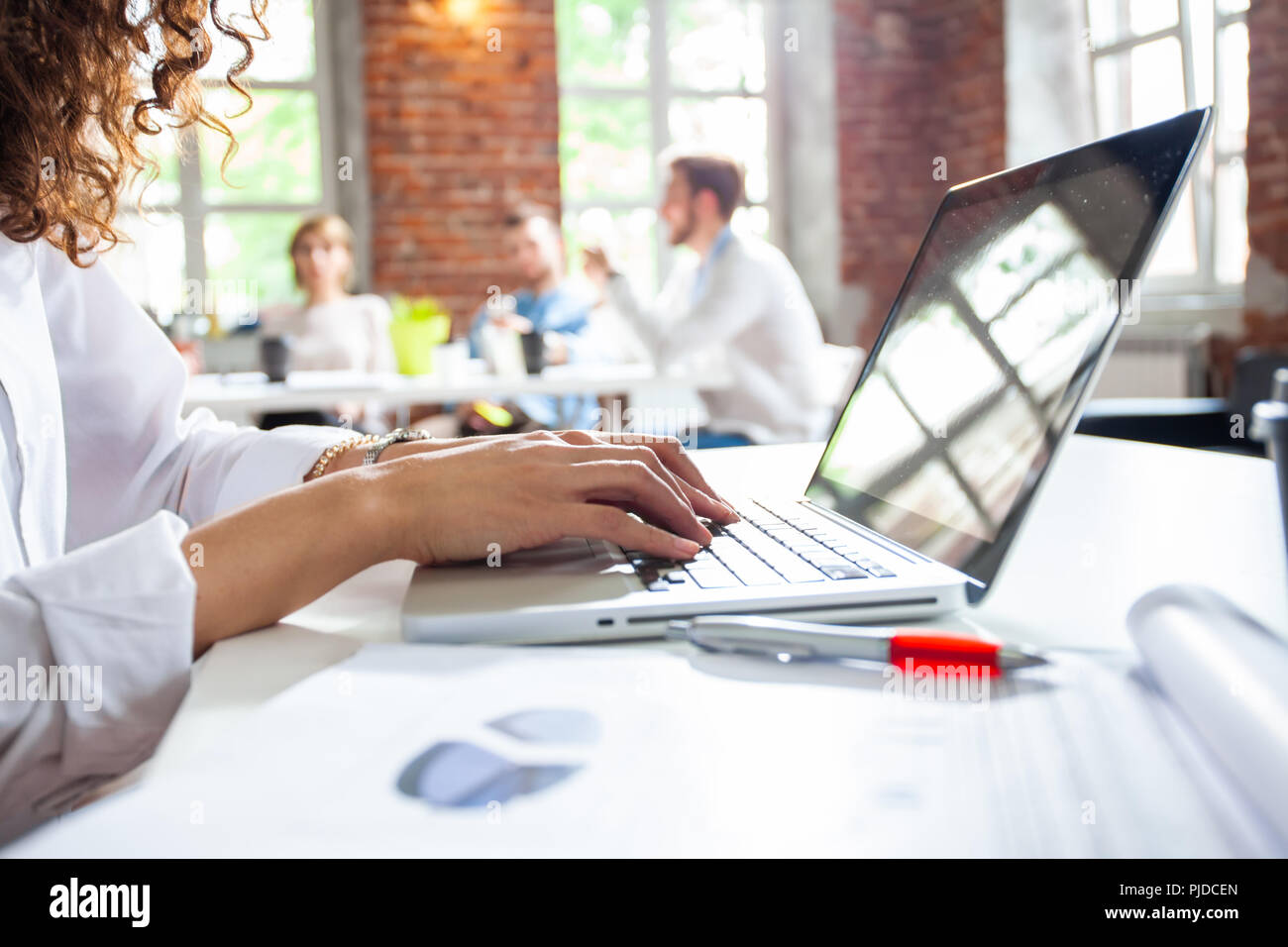 Business woman typing report and take note on laptop during the meeting ...