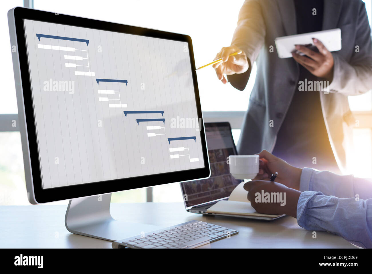 Business People Analyzing PROJECT MANAGEMENT updating Gantt chart Stock ...