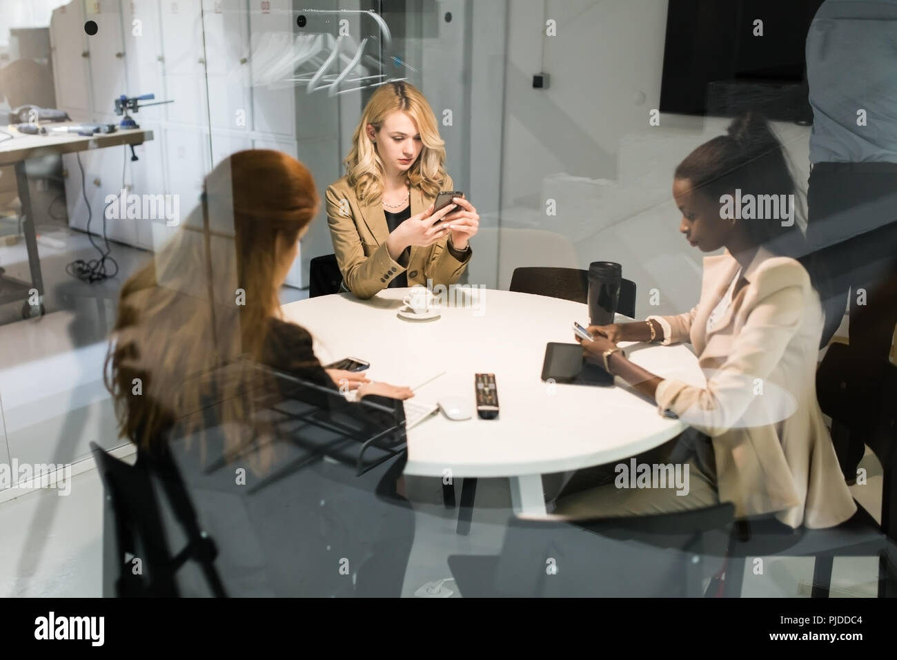 Group of business people sitting at desk Stock Photo - Alamy