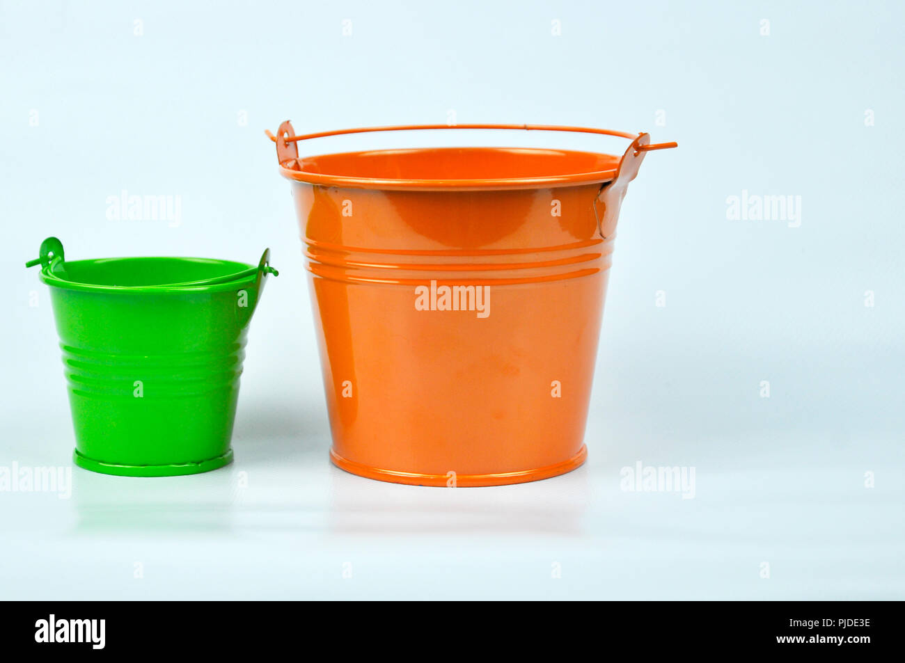 Small orange and green buckets isolated on white background Stock Photo ...