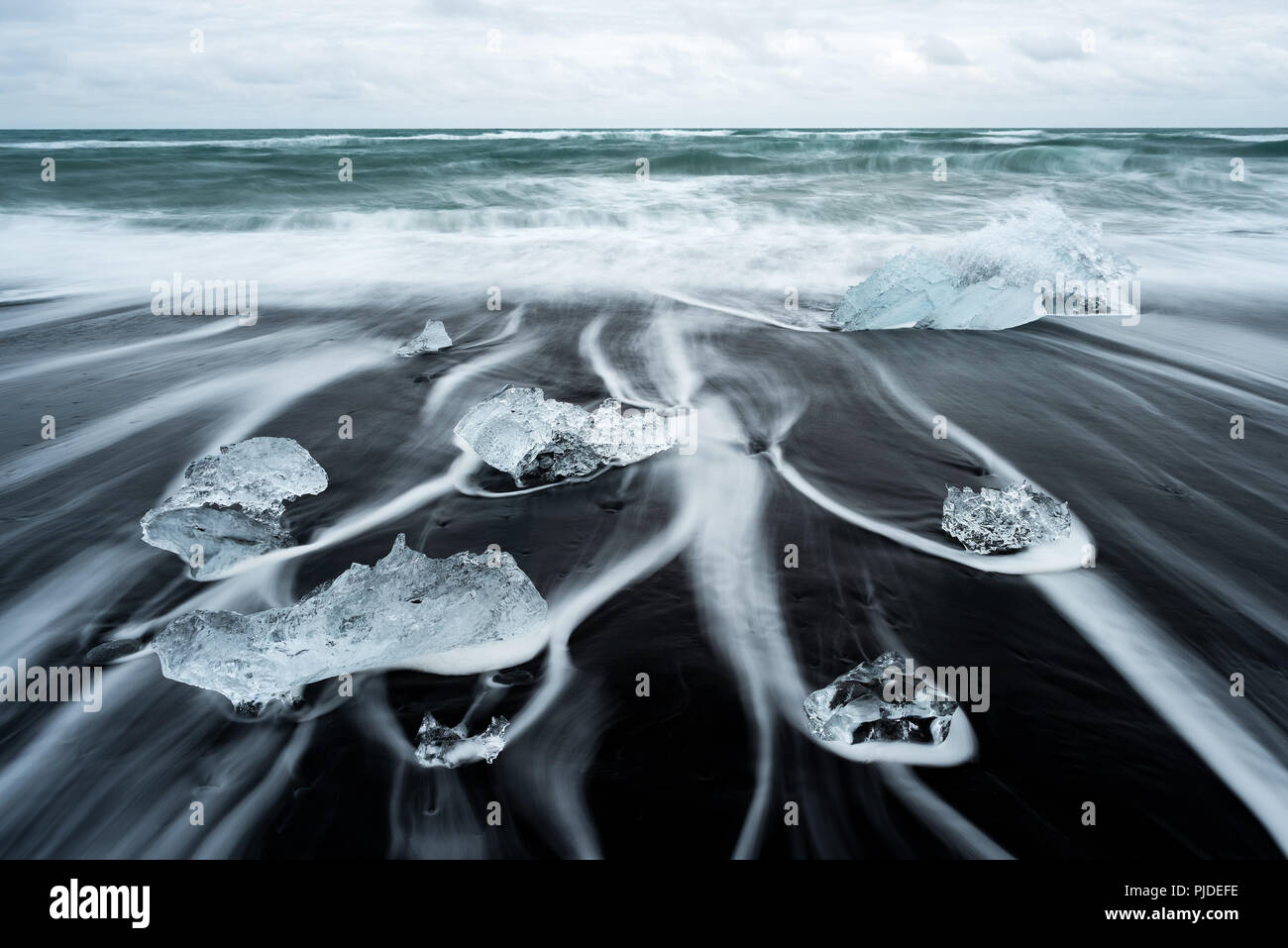 Icy beach in Iceland. Iceberg on the black volcanic sand on the ...