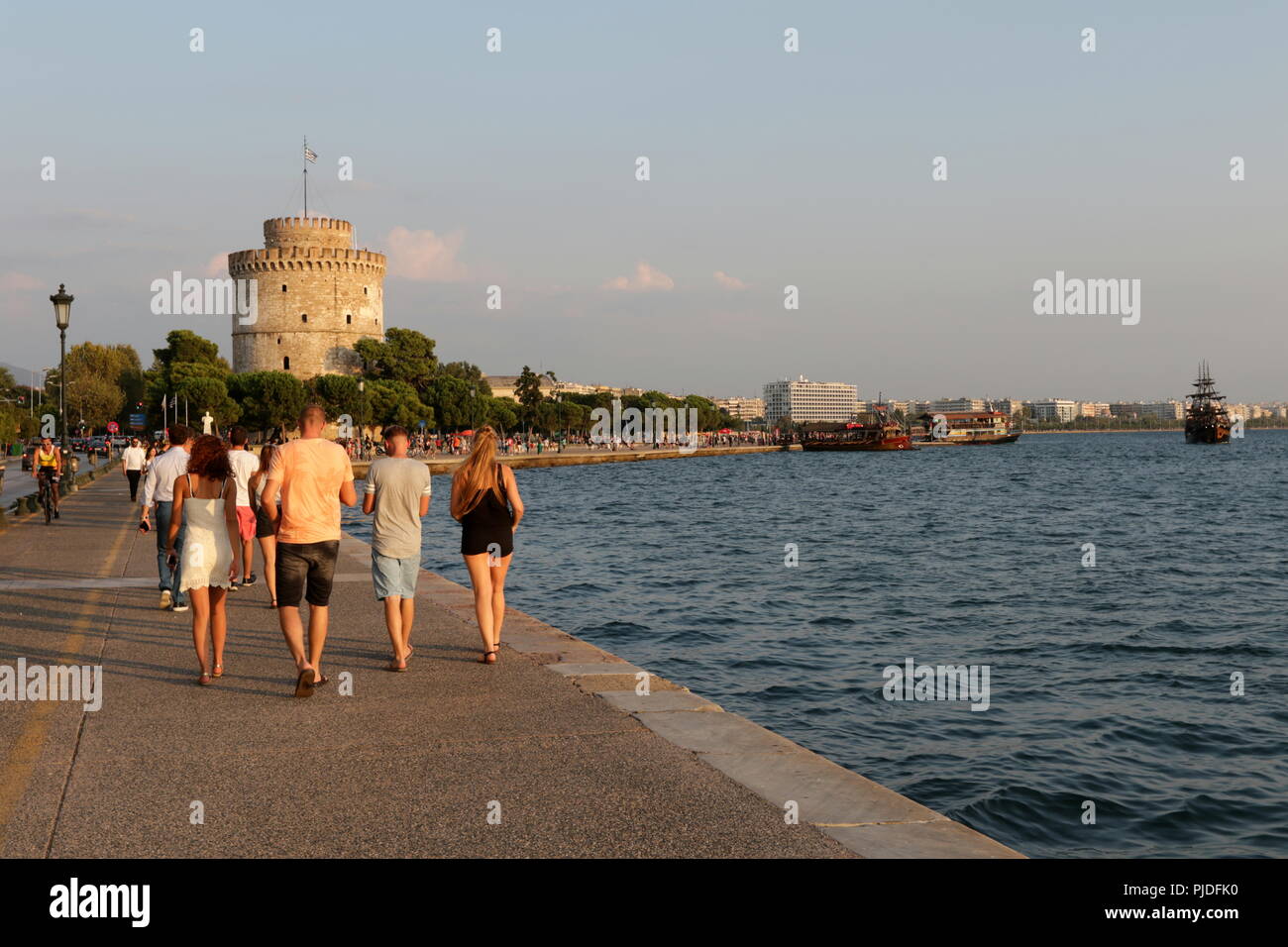 People walk across the old waterfront (palia paralia) towards the White ...