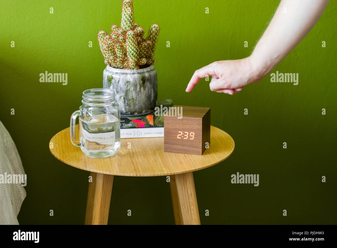 A girl setting the time on a clock Stock Photo - Alamy