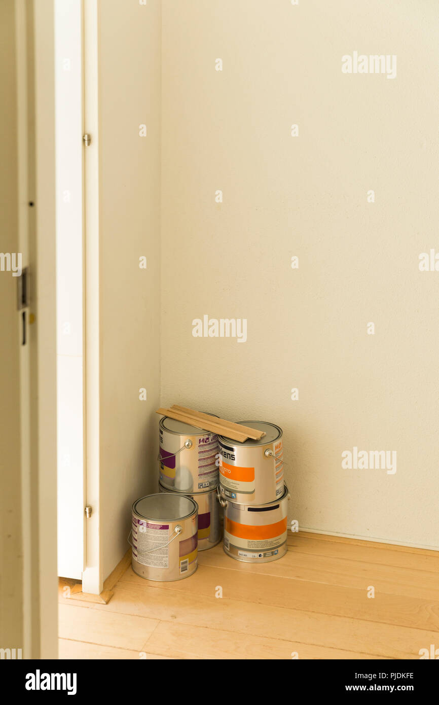 Paint tins sitting inside home ready for use. Left stacked for the ...