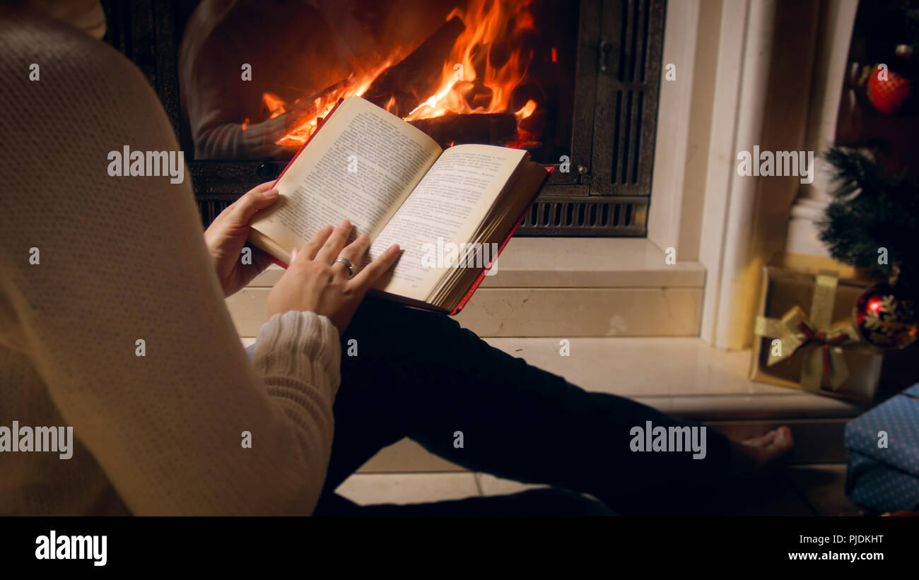 One woman reading book indoors fire hi-res stock photography and images ...