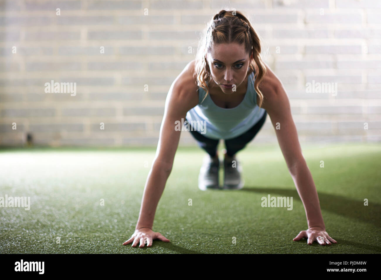 Woman doing plank in gym Stock Photo - Alamy