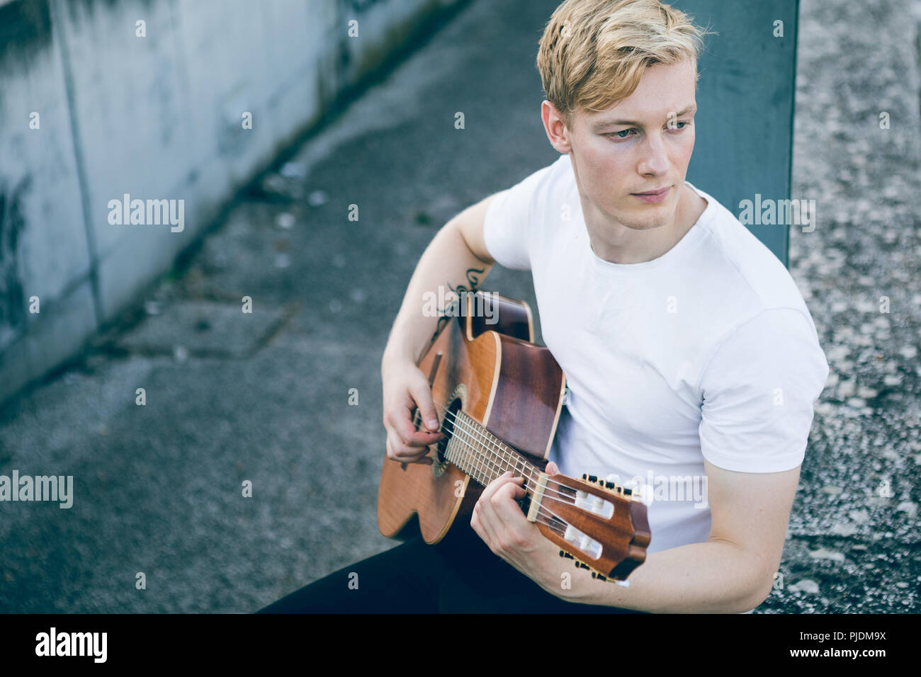 Young musician playing guitar Stock Photo - Alamy
