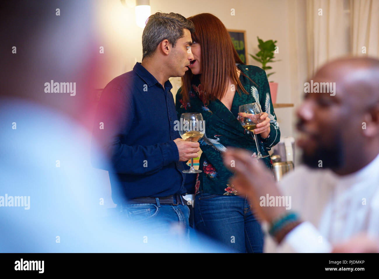 Couple whispering at dinner party hi-res stock photography and images ...