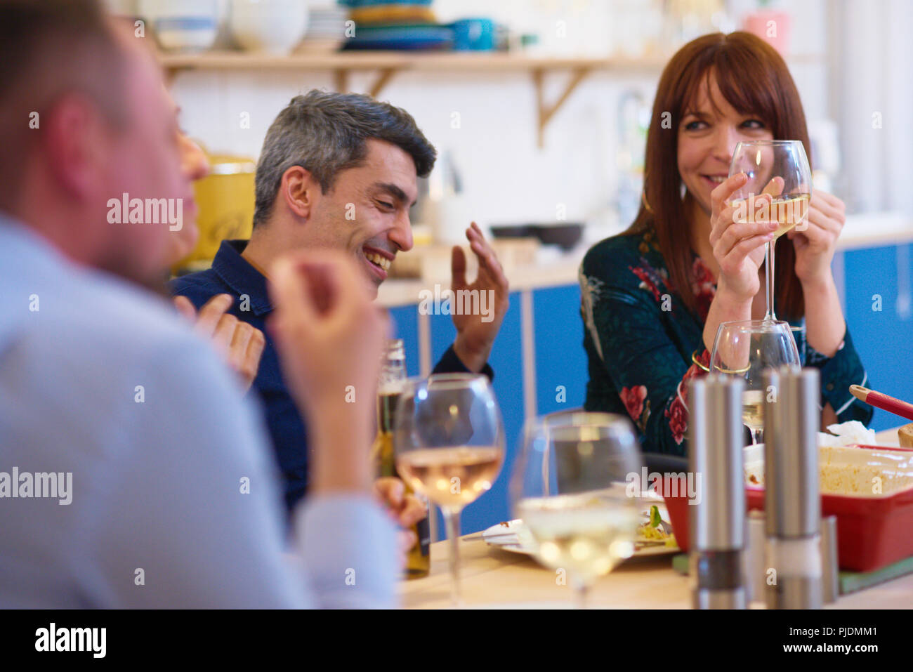 Smiling friends talking at dinner party hi-res stock photography and ...