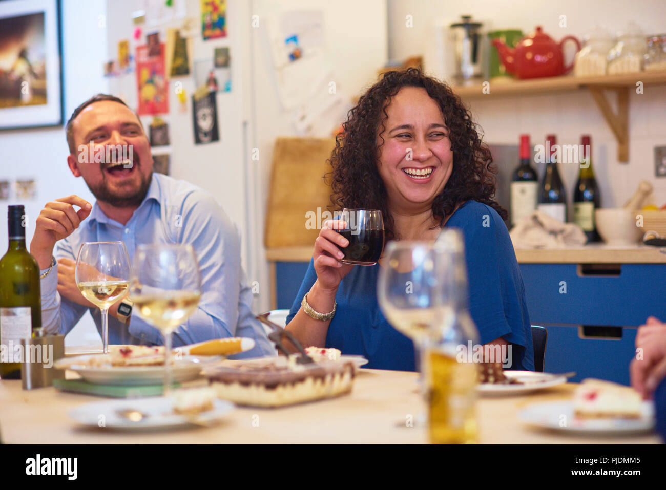 People laughing at dinner table hi-res stock photography and images - Alamy