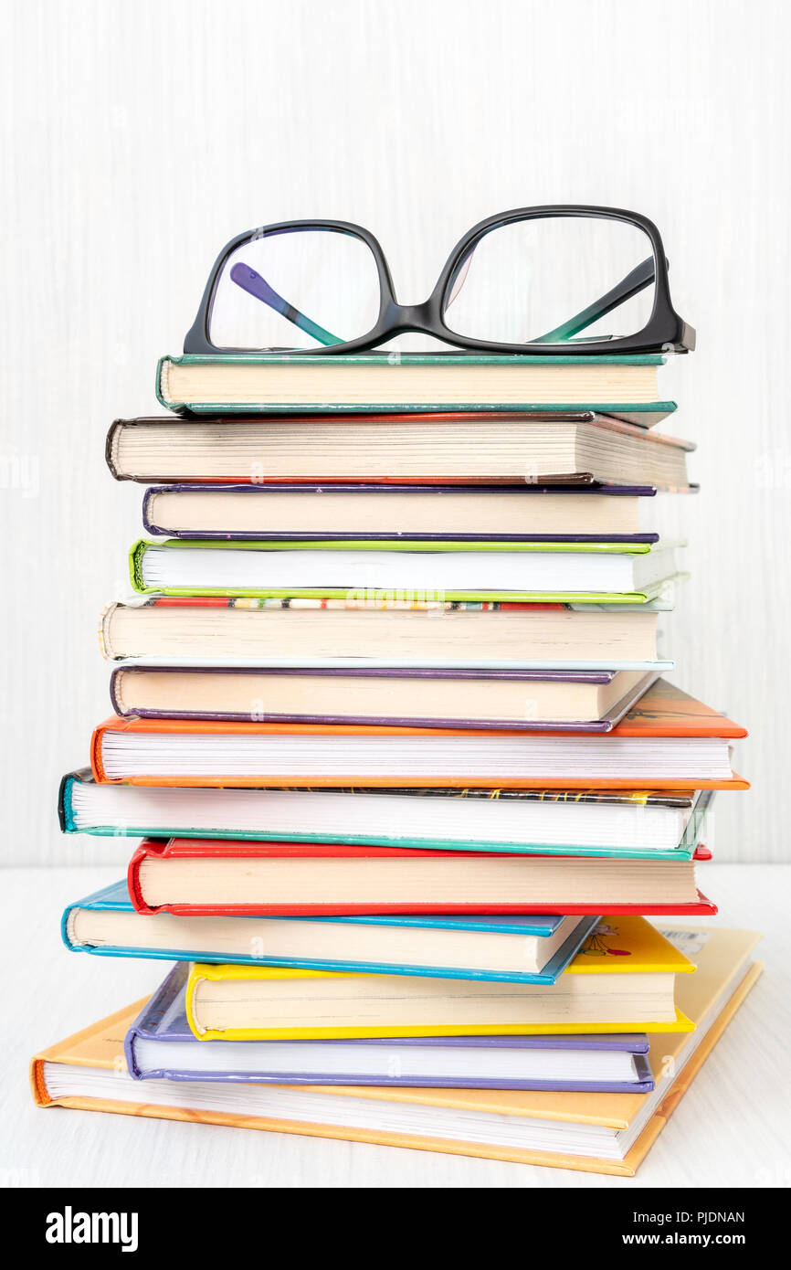 Stack of books with a eyeglasses on top.Reading, literature,education ...