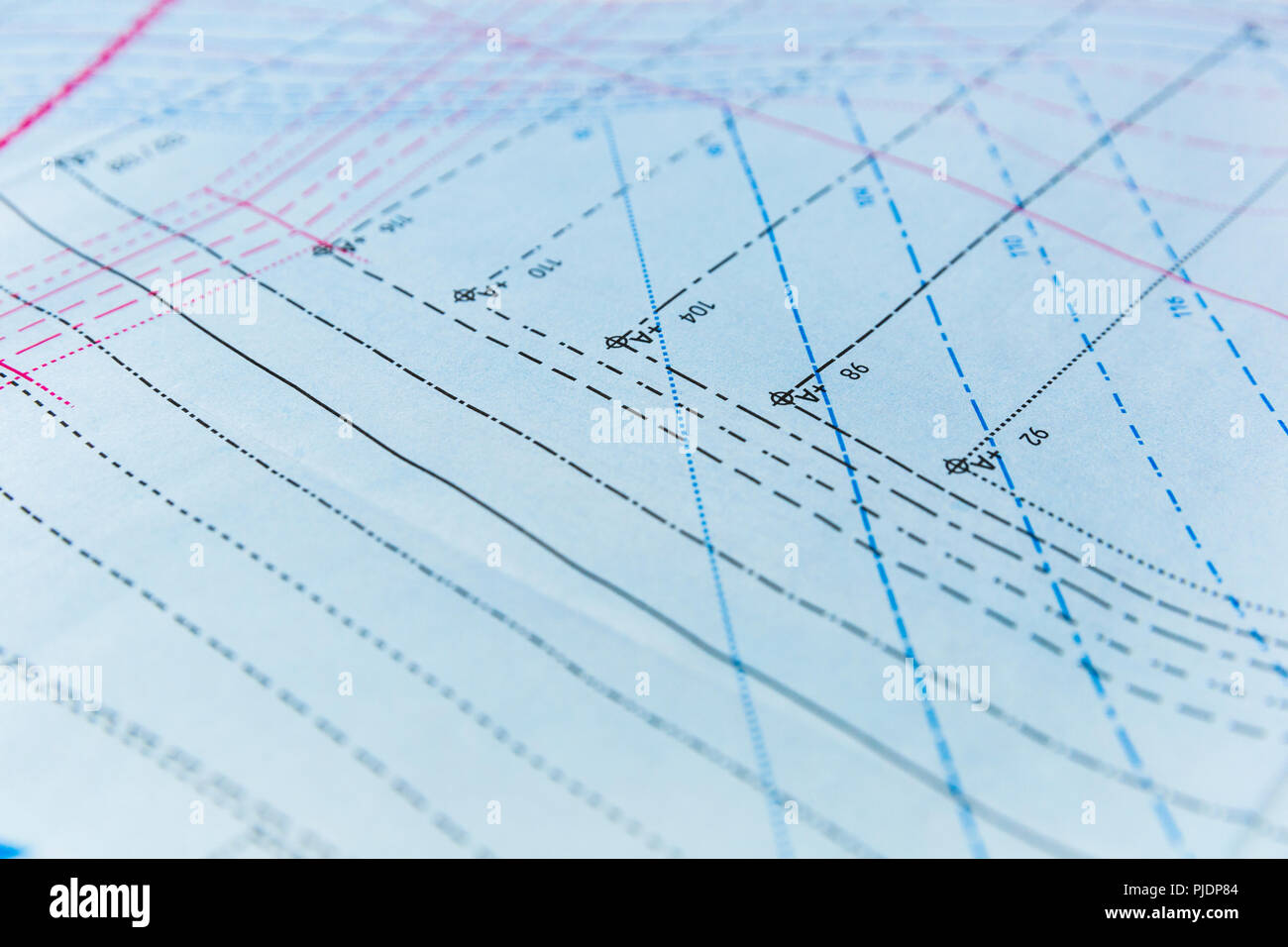 Blue textile guide lines on paper laid out on work bench Stock Photo ...