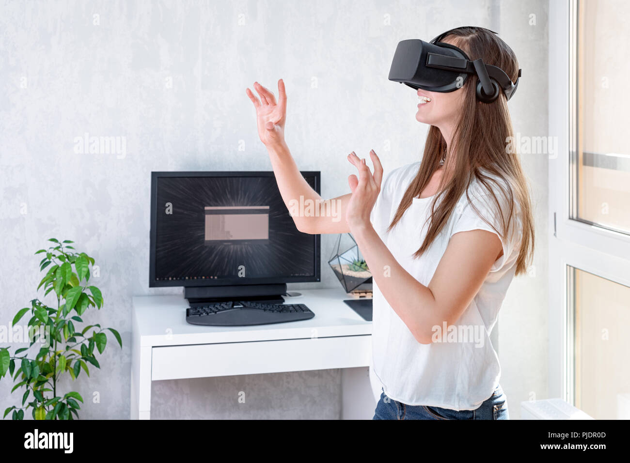 Smiling positive woman wearing virtual reality goggles headset, vr box ...