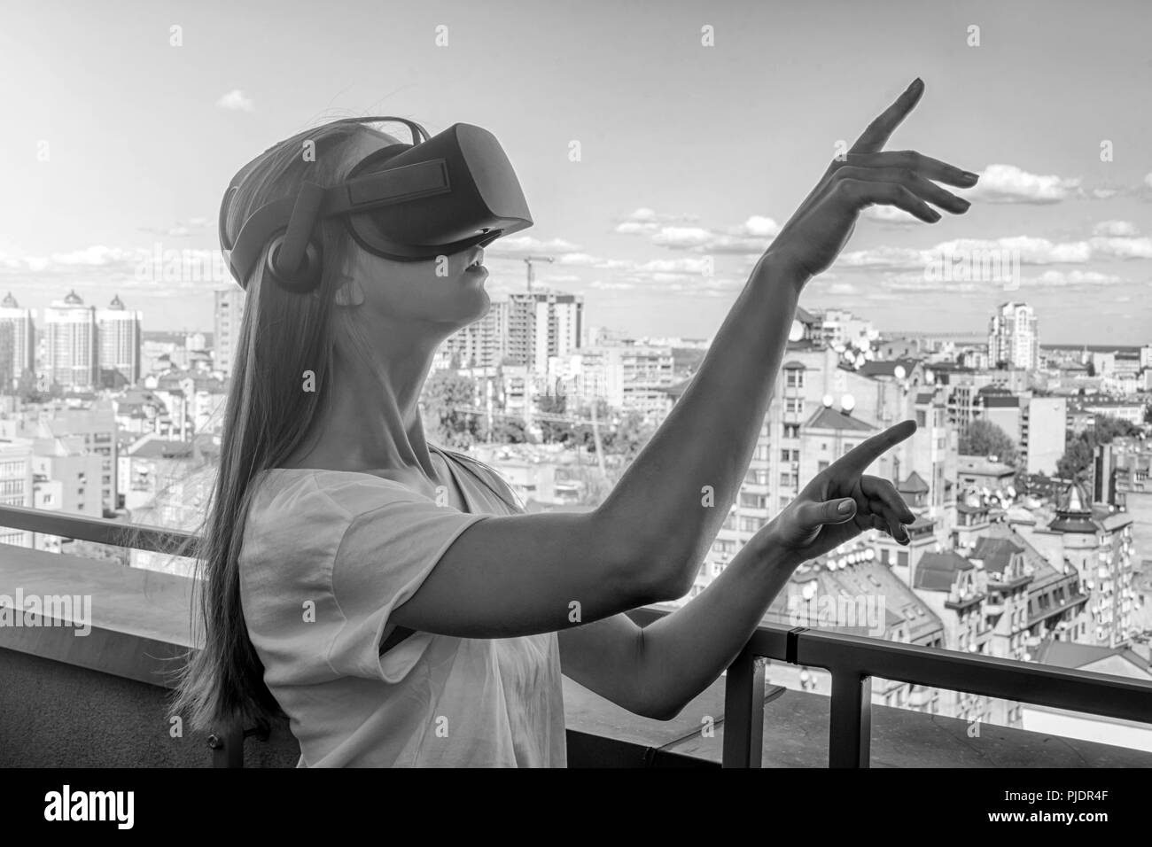 Young woman wearing virtual reality goggles headset, vr box outdoors ...