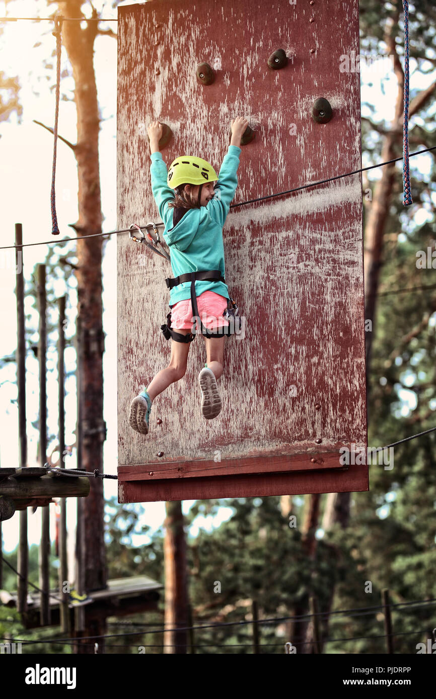 climbing a young girl on a rope park Stock Photo - Alamy